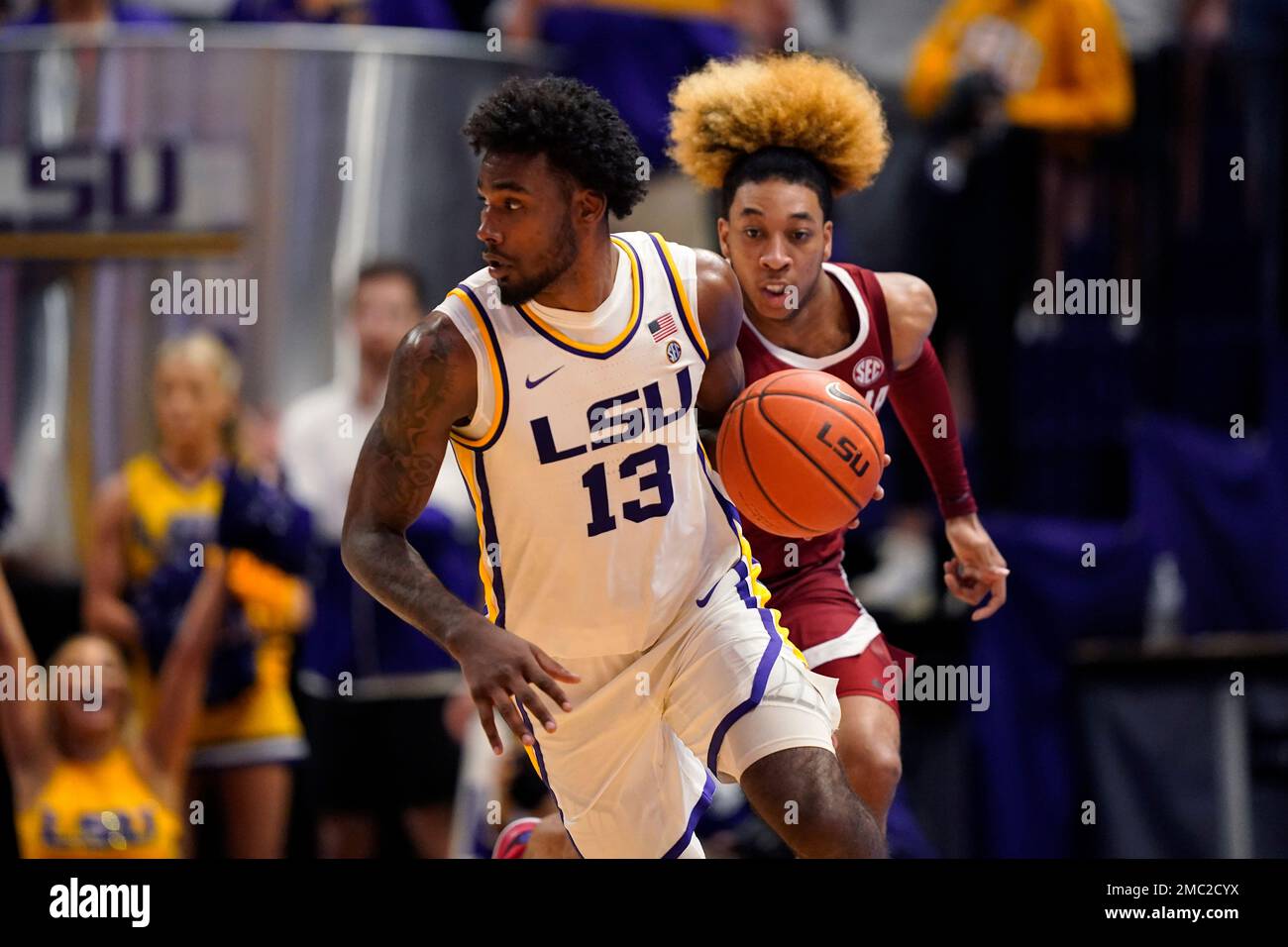 LSU forward Tari Eason (13) moves the ball past Alabama guard JD ...
