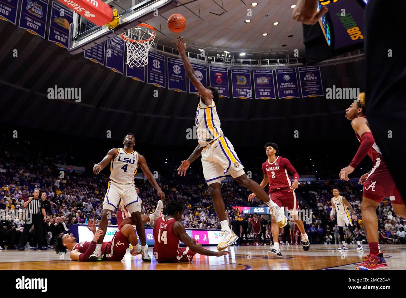 LSU forward Tari Eason (13) goes to the basket over Alabama guard Keon ...