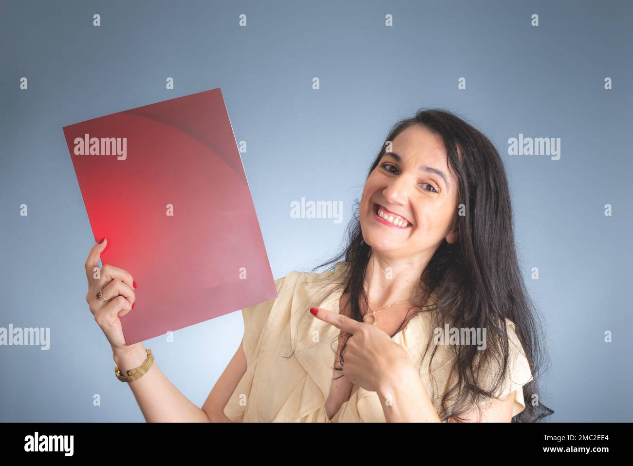 Portrait of professional female lawyer showing flyer from her office ...