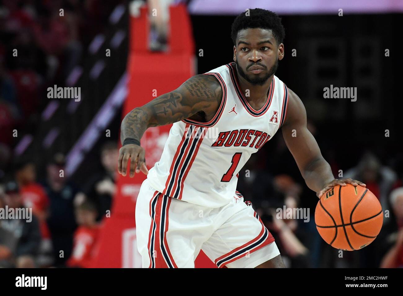 Houston guard Jamal Shead (1) brings the ball up court against Temple ...