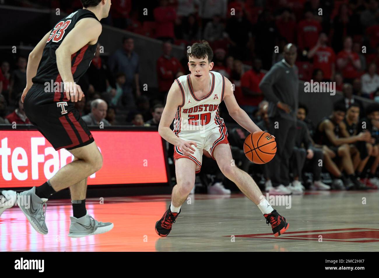Houston guard Ryan Elvin (20) controls the ball against Temple during ...