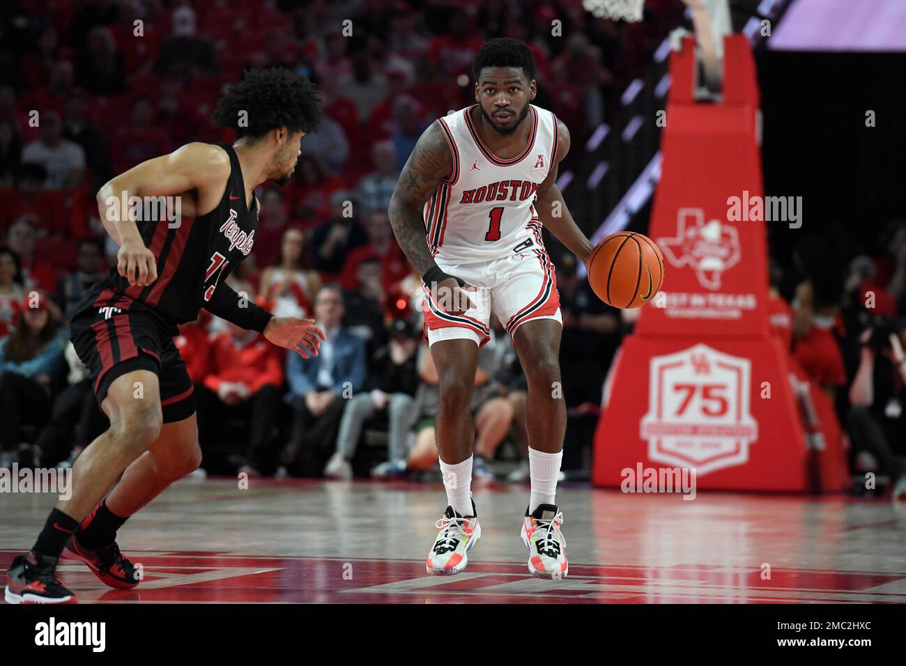 Houston guard Jamal Shead (1) brings the ball up court against Temple ...
