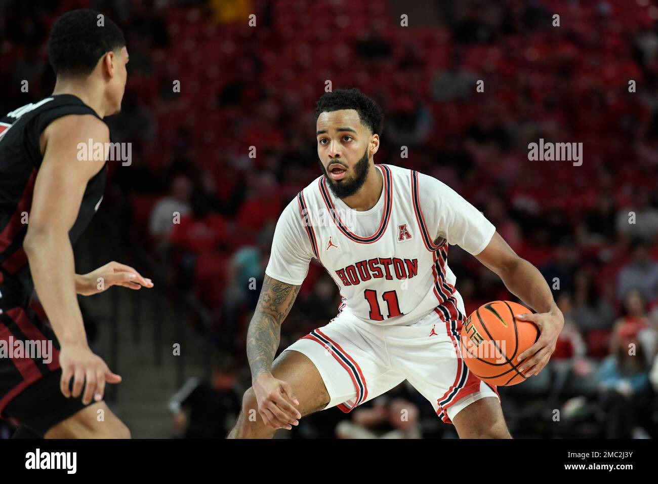Houston guard Kyler Edwards (11) controls the ball against Temple ...