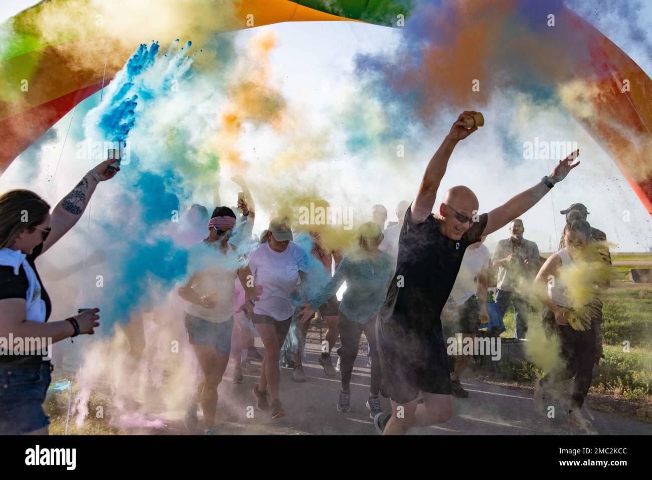 Airmen and families run through the starting line at the Pride Month ...