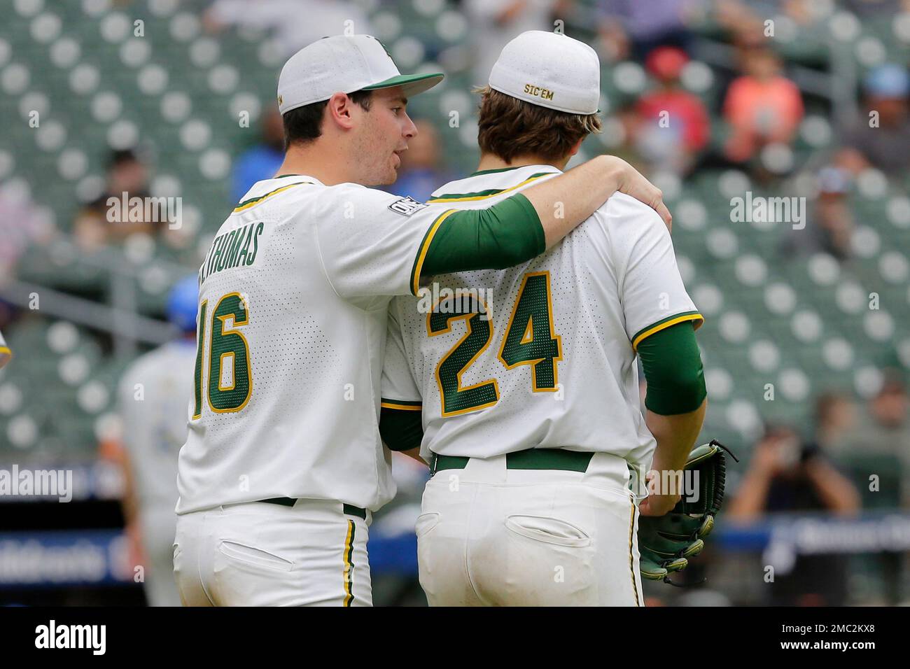 Baylor starting pitcher Tyler Thomas (16) hugs reliever Mason Marriott ...
