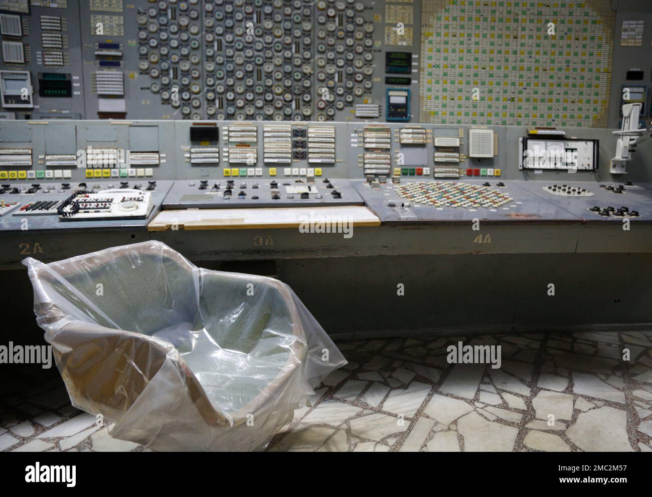 FILE - An operator's arm-chair covered with plastic sits in an empty ...