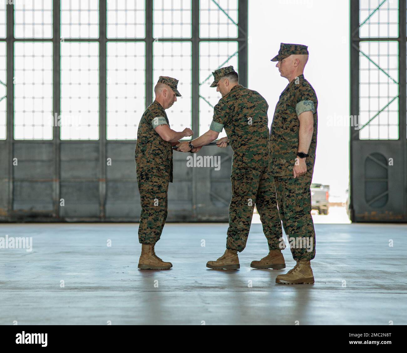 U.S. Marine Corps Sgt. Maj. Thomas R. Coffey, left, receives the non ...
