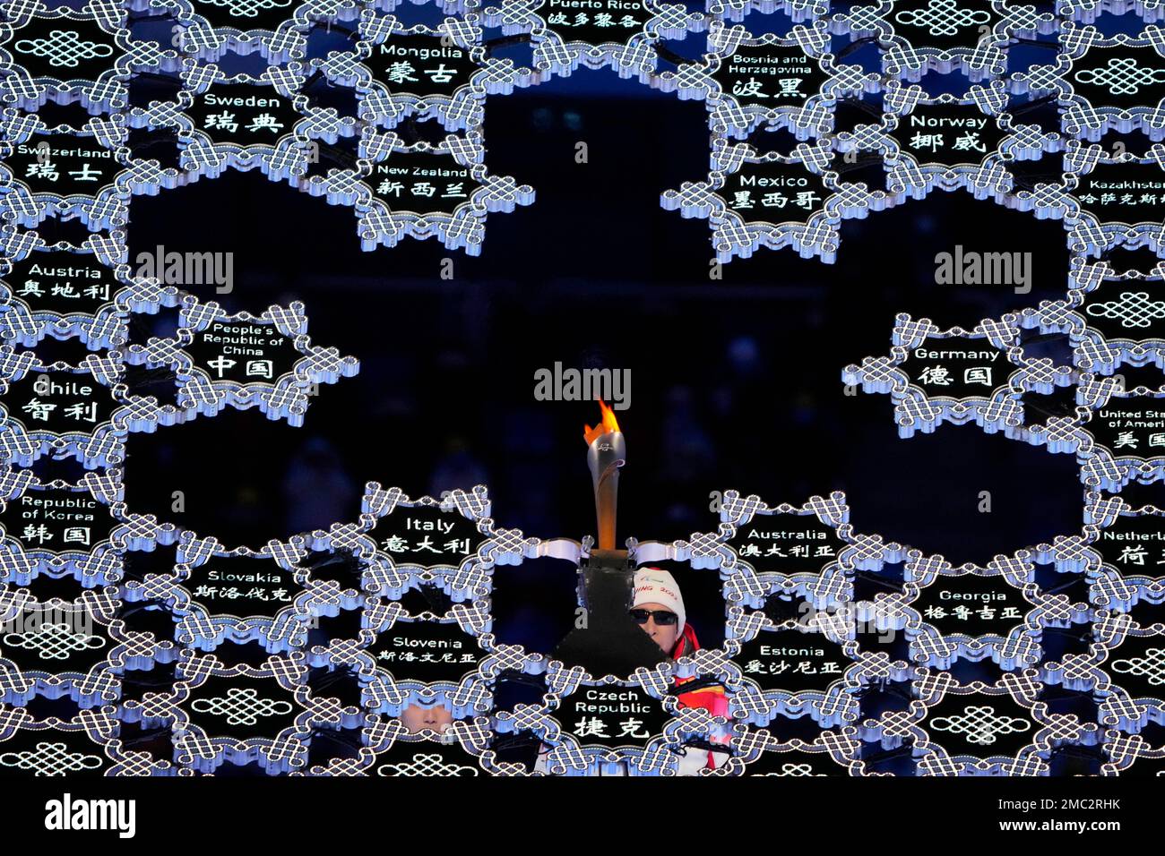 Torchbearer and former Chinese Paralympian Li Duan lights the ...