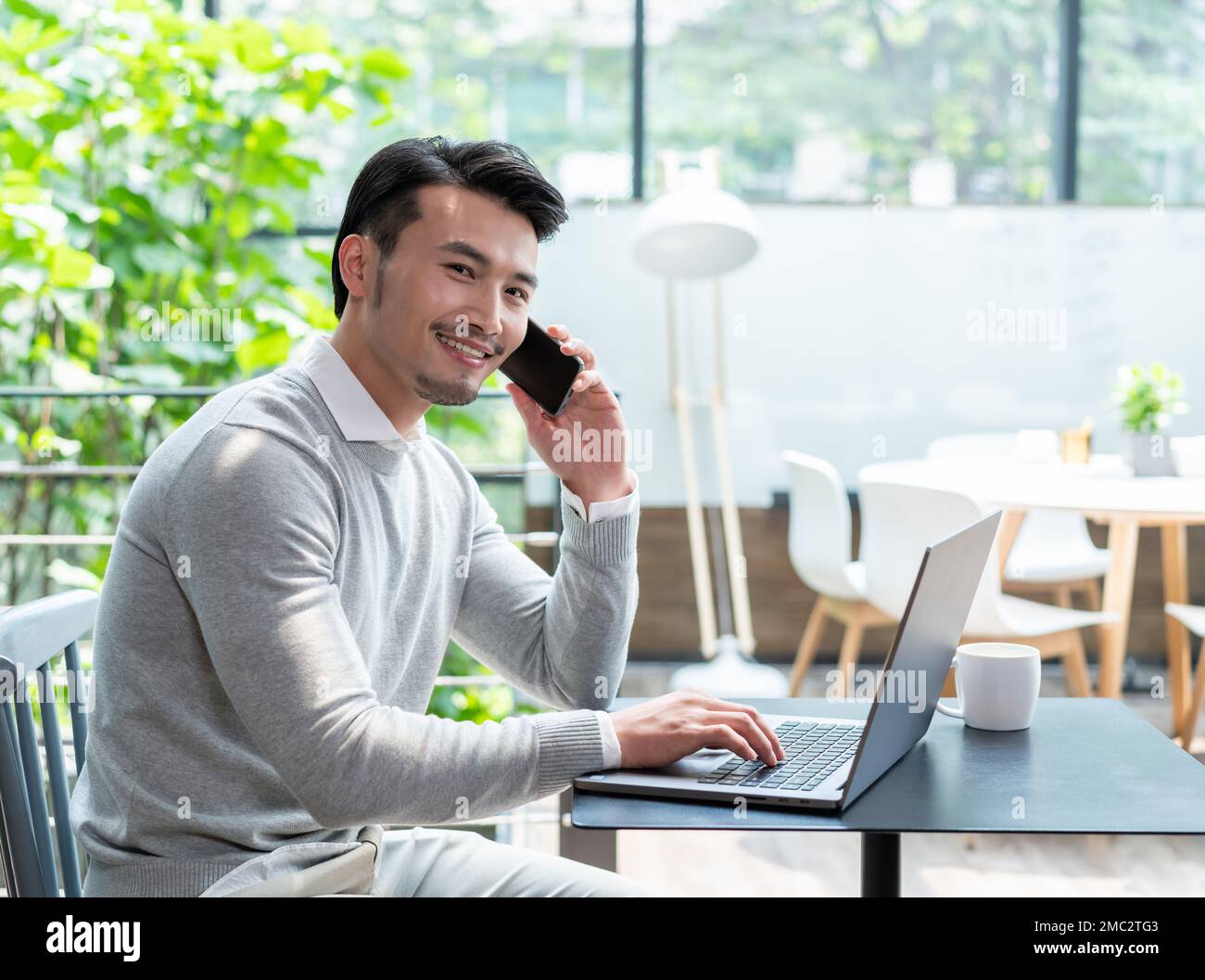 Young men who use a computer Stock Photo - Alamy