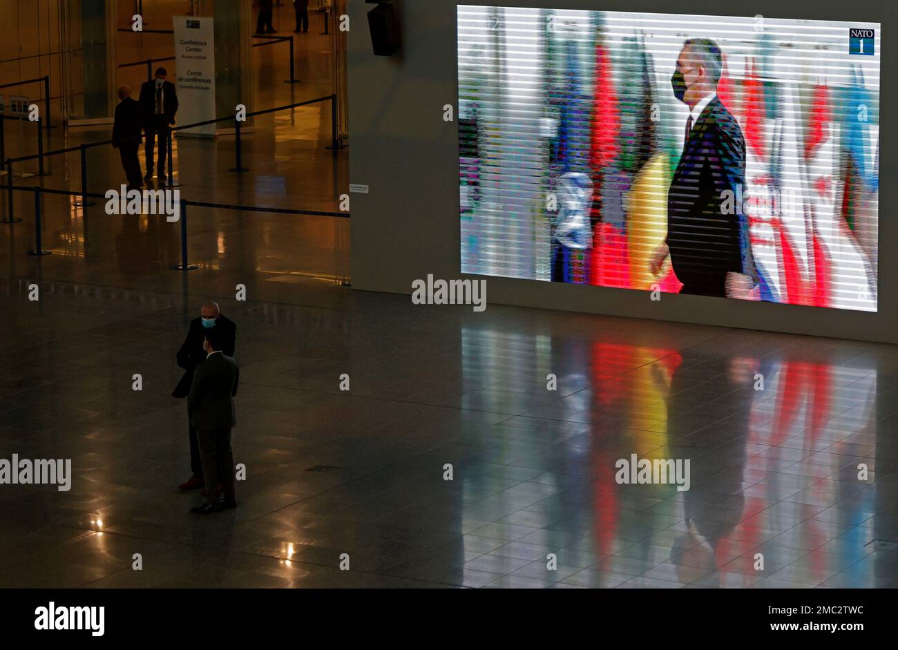 NATO Secretary General Jens Stoltenberg is shown on a large screen as ...
