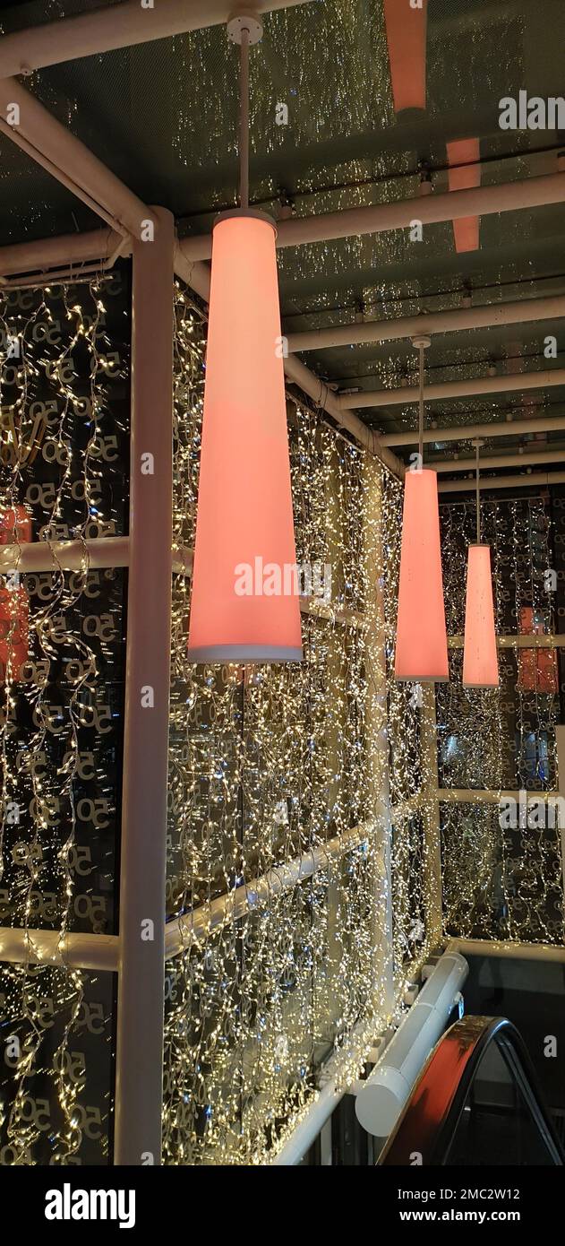 Decorative lamps hanging from the ceiling with yellow mini lights on ...