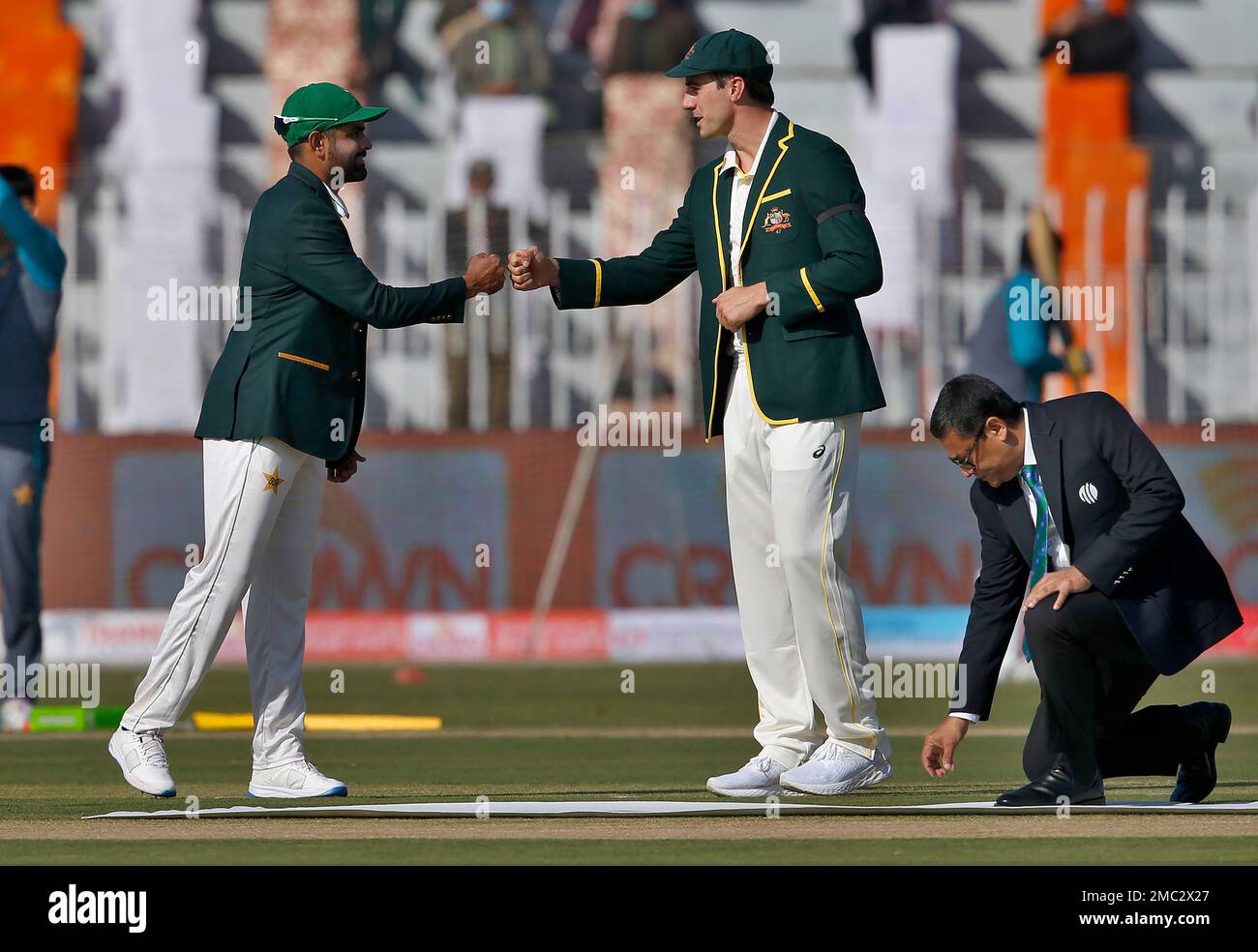 Pakistan's skipper Babar Azam, left, thumbs up with his Australian counterpart Pat Cummins after ...