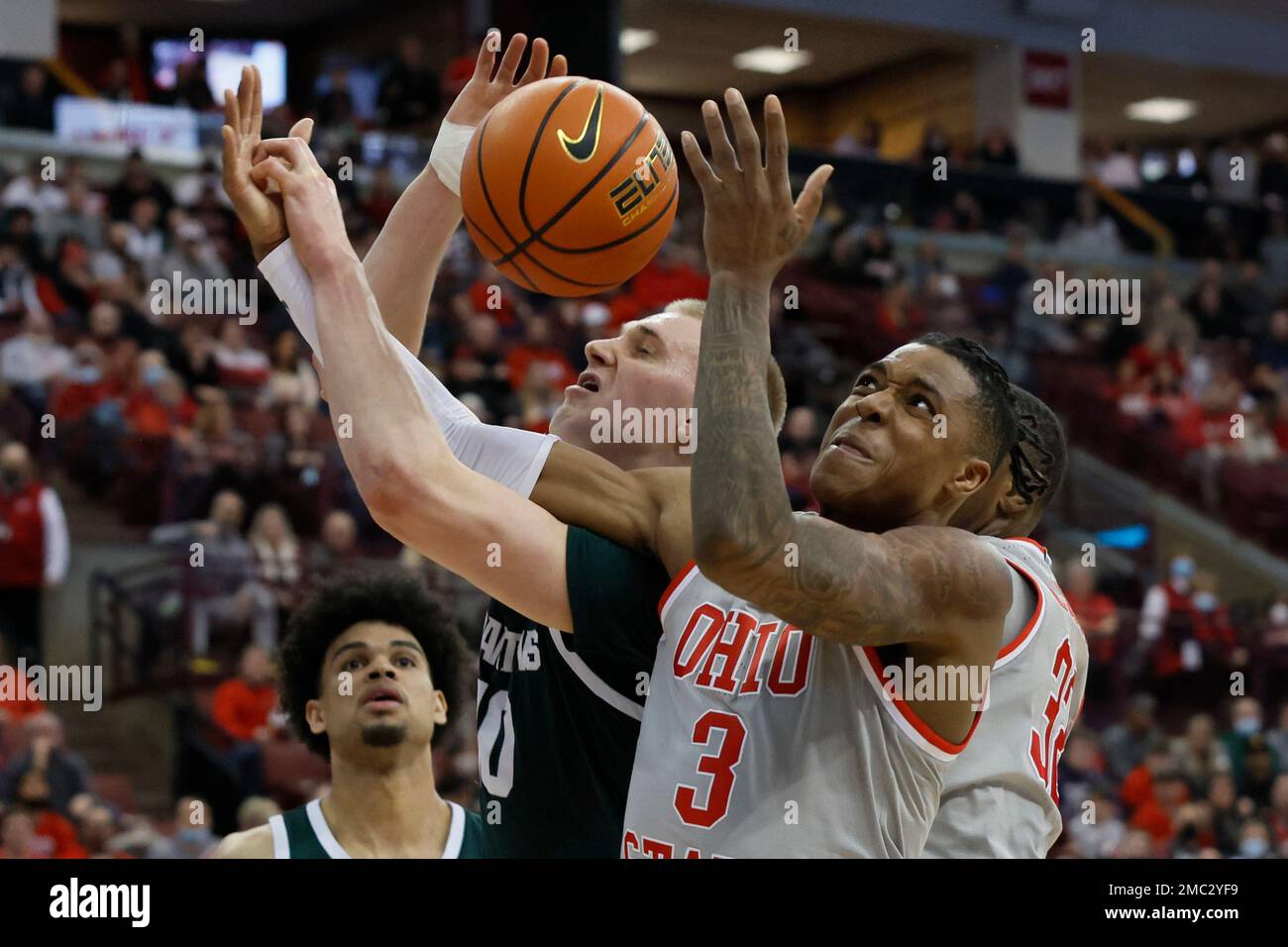 Michigan State's Joey Hauser, left, and Ohio State's Eugene Brown vie ...