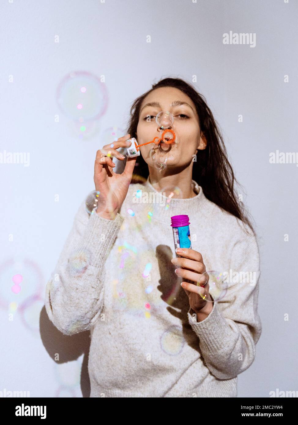 Attractive young woman blowing bubble hi-res stock photography and ...