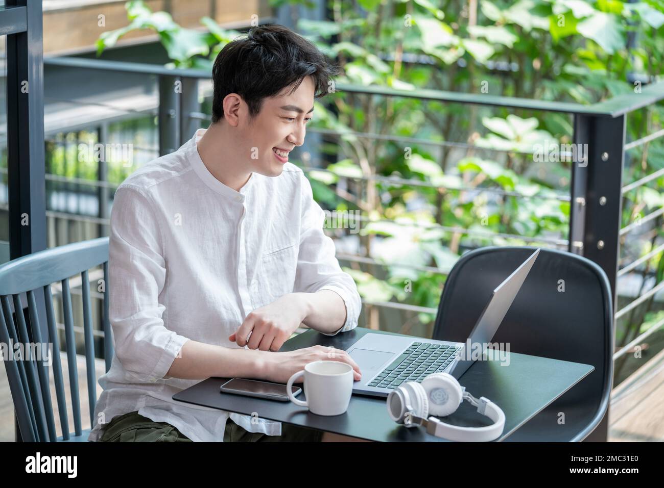 Young men who use a computer Stock Photo - Alamy