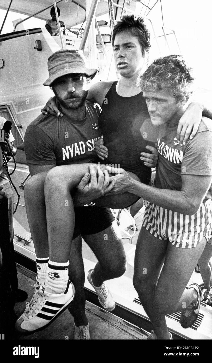 Marathon swimmer Diana Nyad, is carried from a boat by two of her ...