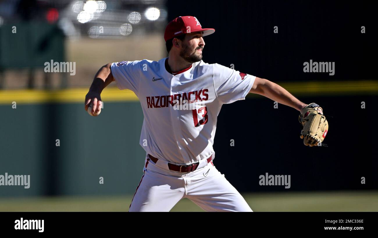 Arkansas pitcher Connor Noland (13) throws to first base against ...
