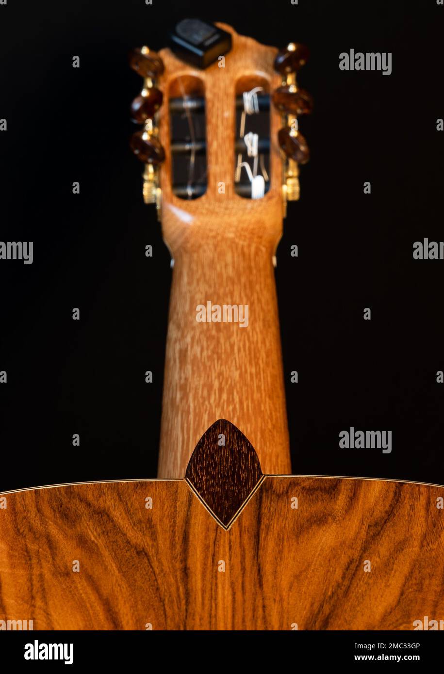 Classical guitar back detail isolated on black background, view from ...