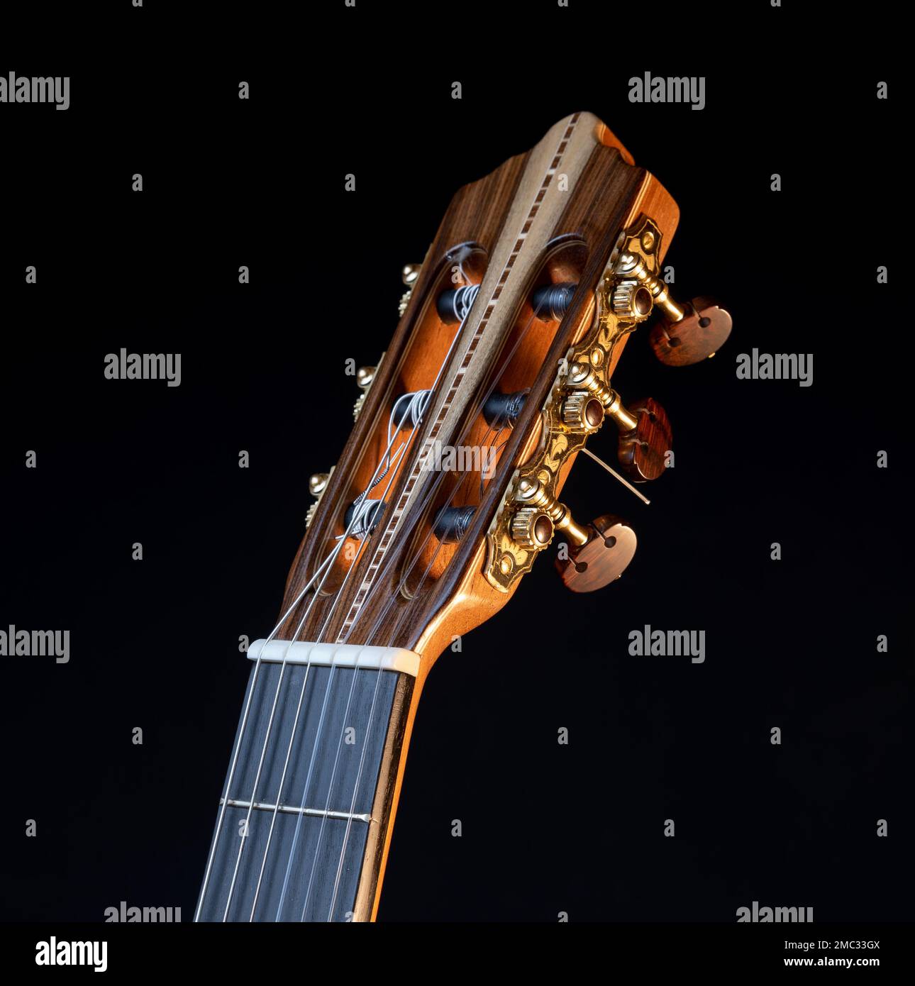 Classical guitar headstock detail isolated on black background. Classic ...