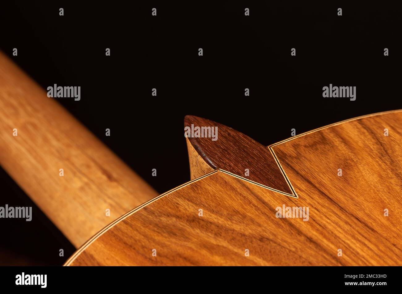 Classical guitar back detail isolated on black background, view from ...