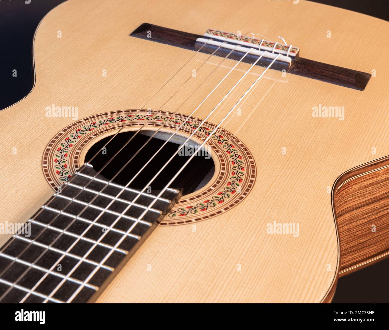 Classical guitar top isolated on black background with a beautiful ...