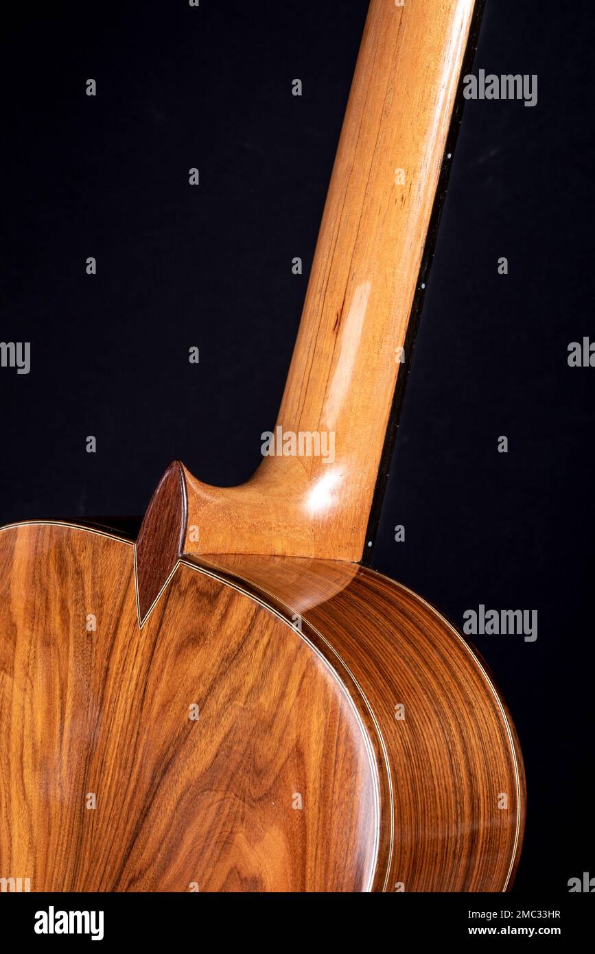 Classical guitar back detail isolated on black background, view from ...