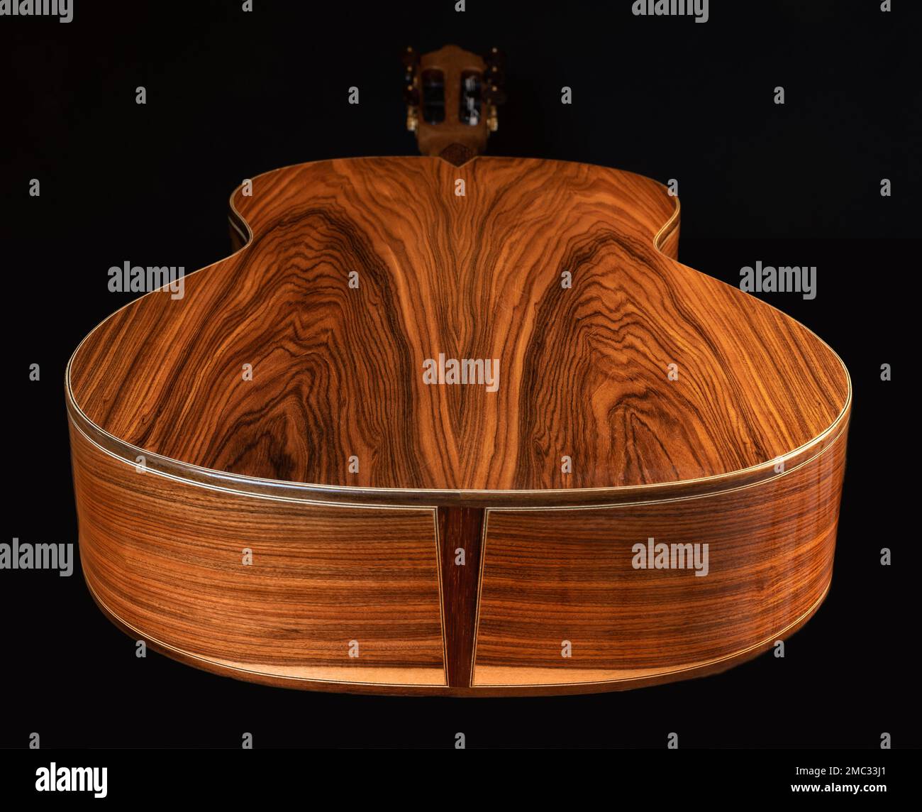 Classical guitar isolated on black background, view from the back side ...