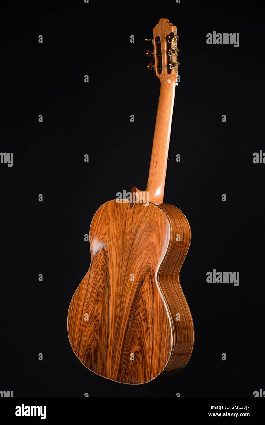 Classical guitar isolated on black background, view from the back side ...