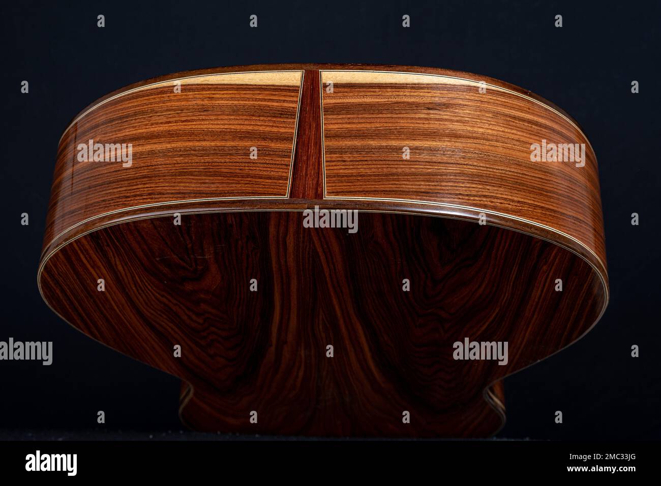 Classical guitar isolated on black background, view from the back side ...