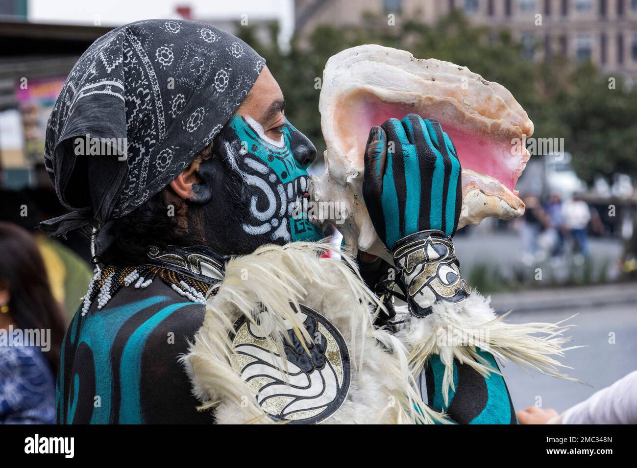 Aztec native, blowing into a large shell, Mexico City, Mexico Stock ...