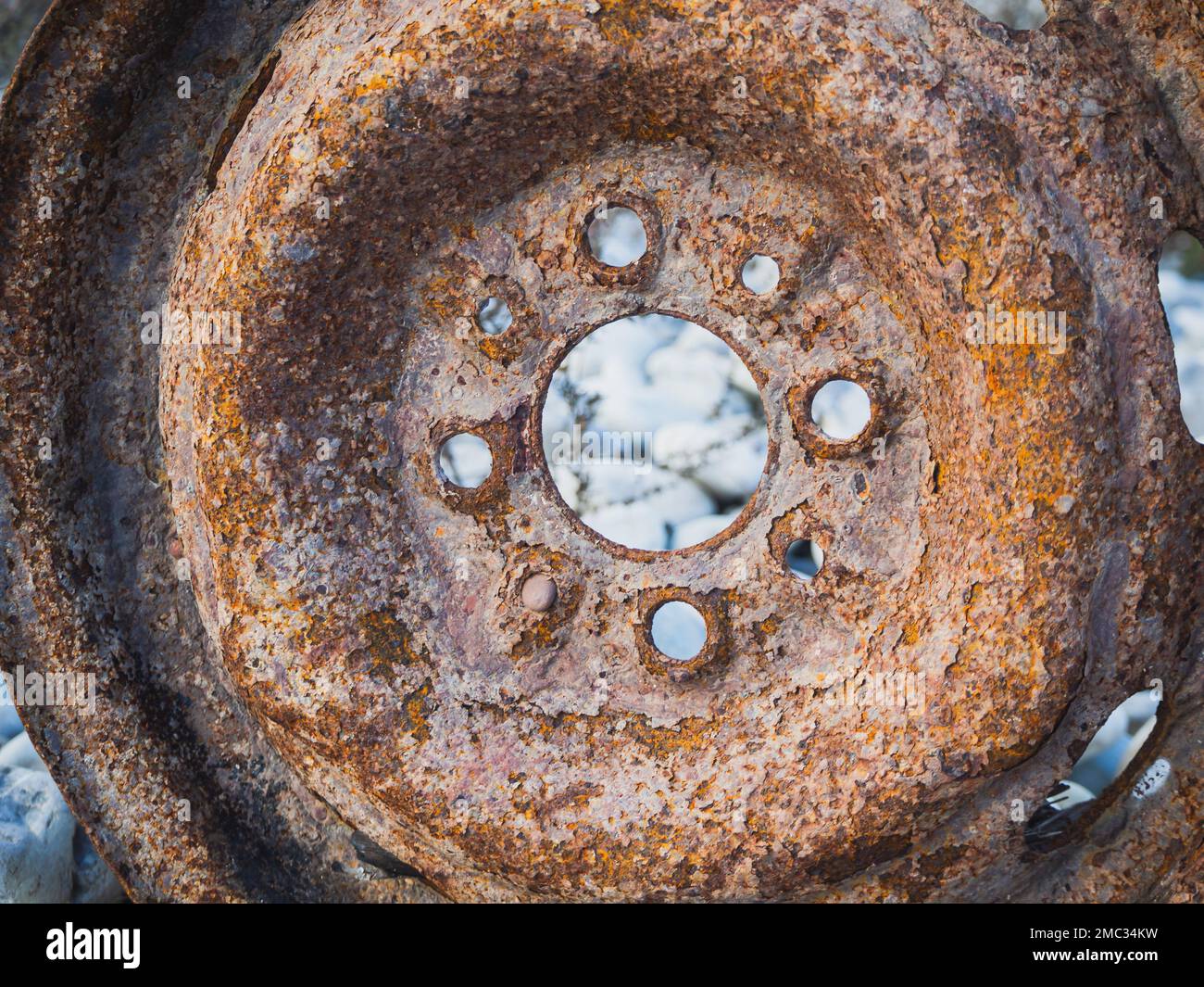 Old car wheel, rusty car alloy rim on stones by the river Stock Photo ...