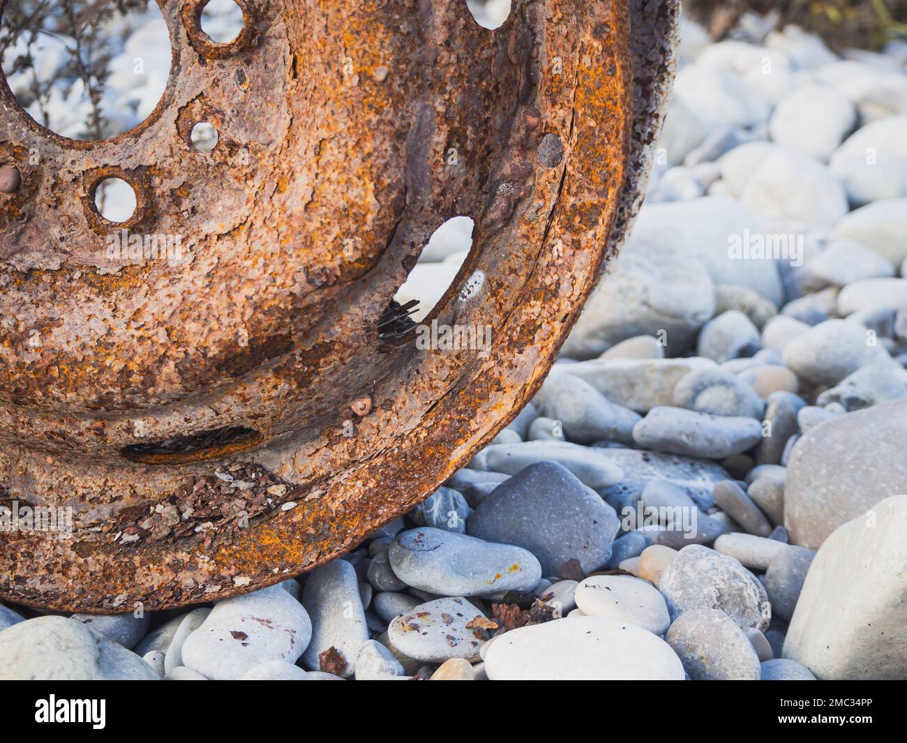 Old car wheel, rusty car alloy rim on stones by the river Stock Photo ...