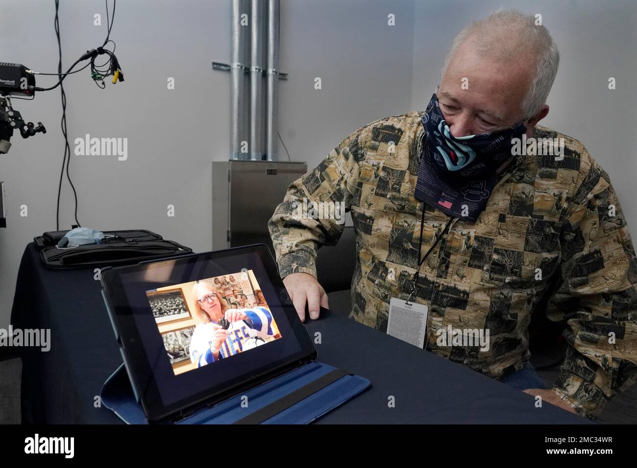 Seattle Kraken organist Rod Masters watches as a video showing Dave ...
