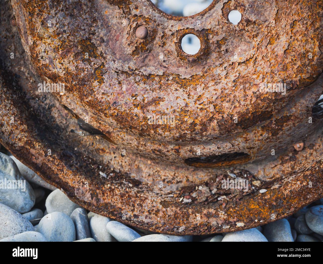 Old car wheel, rusty car alloy rim on stones by the river Stock Photo ...