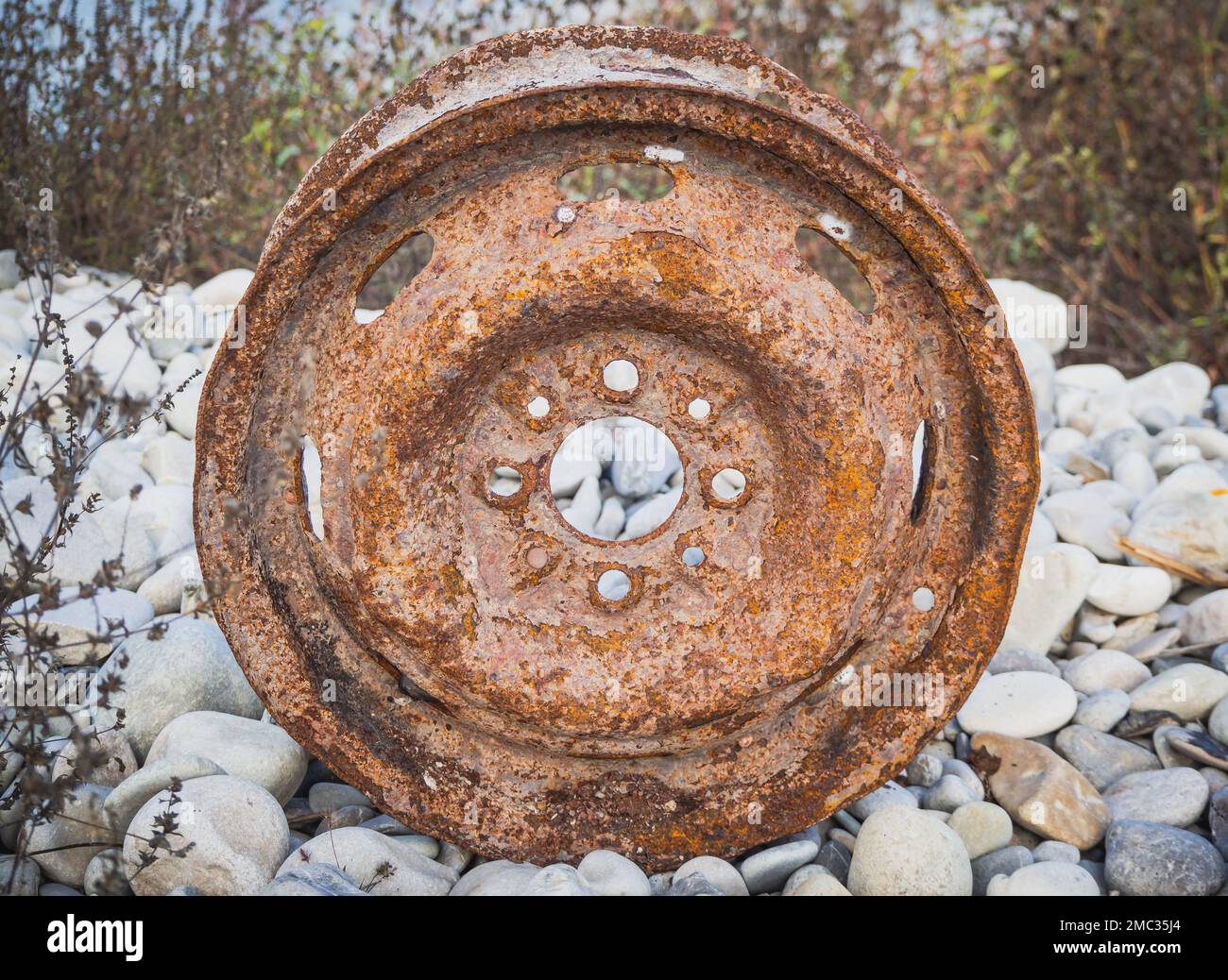 Old car wheel, rusty car alloy rim on stones by the river Stock Photo ...