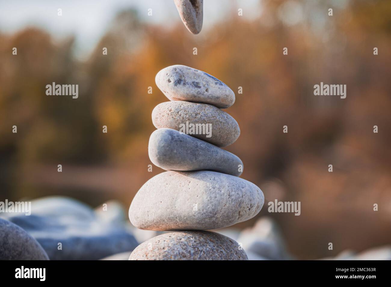Young woman building stone stack hi-res stock photography and images ...