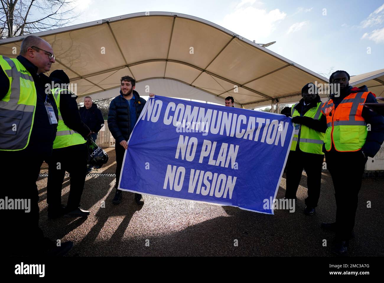 An Everton fan holds up a banner of protest prior to the Premier League ...