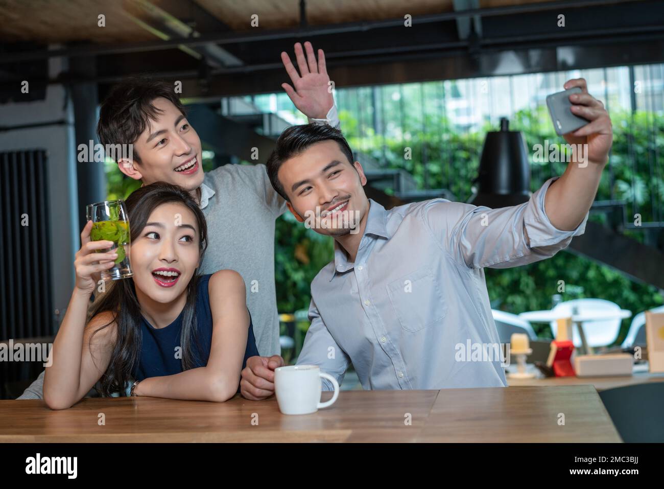 Happy friends party see a mobile phone Stock Photo - Alamy