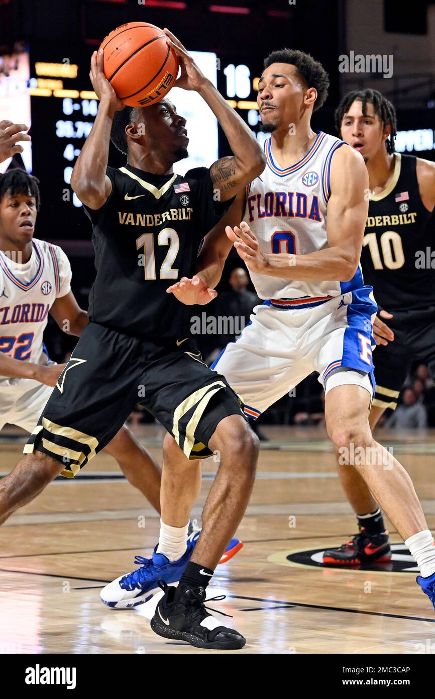 Vanderbilt guard Trey Thomas (12) drives against Florida guard Myreon ...