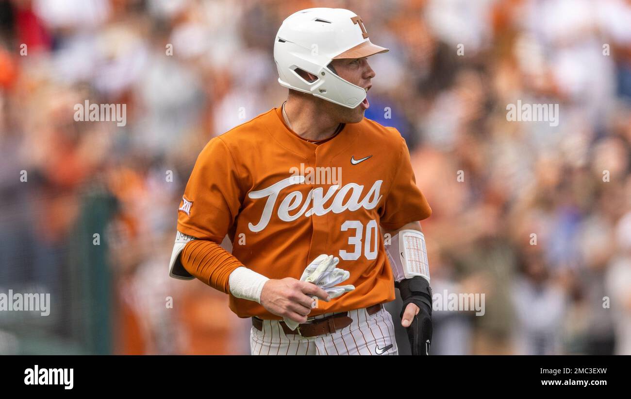 Texas outfielder Eric Kennedy celebrates scoring against Rice during an ...