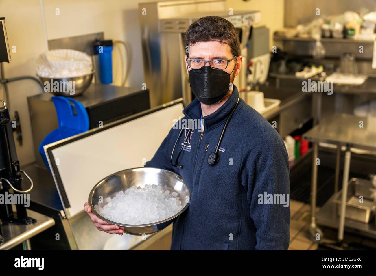 Dr. Alexander St. John poses for a photo in front of an ice maker in a ...