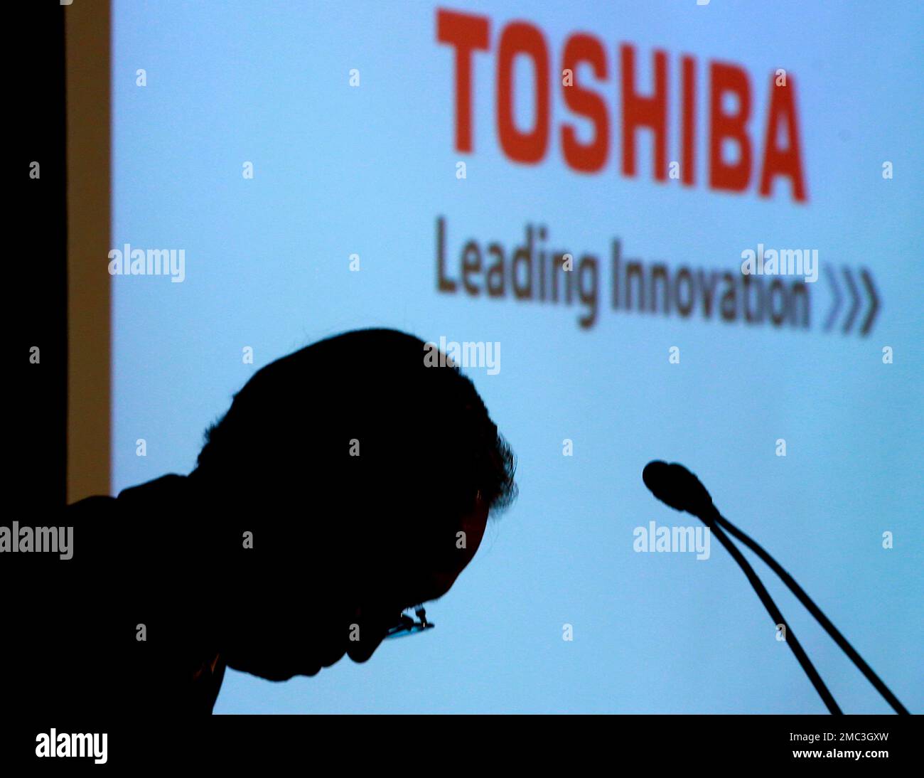FILE - Toshiba Corp.'s President Satoshi Tsunakawa bows during a press ...