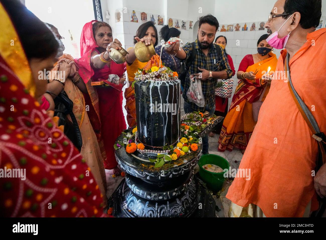 Hindu devotees worship a Shivling, a representation of Hindu god Shiva ...