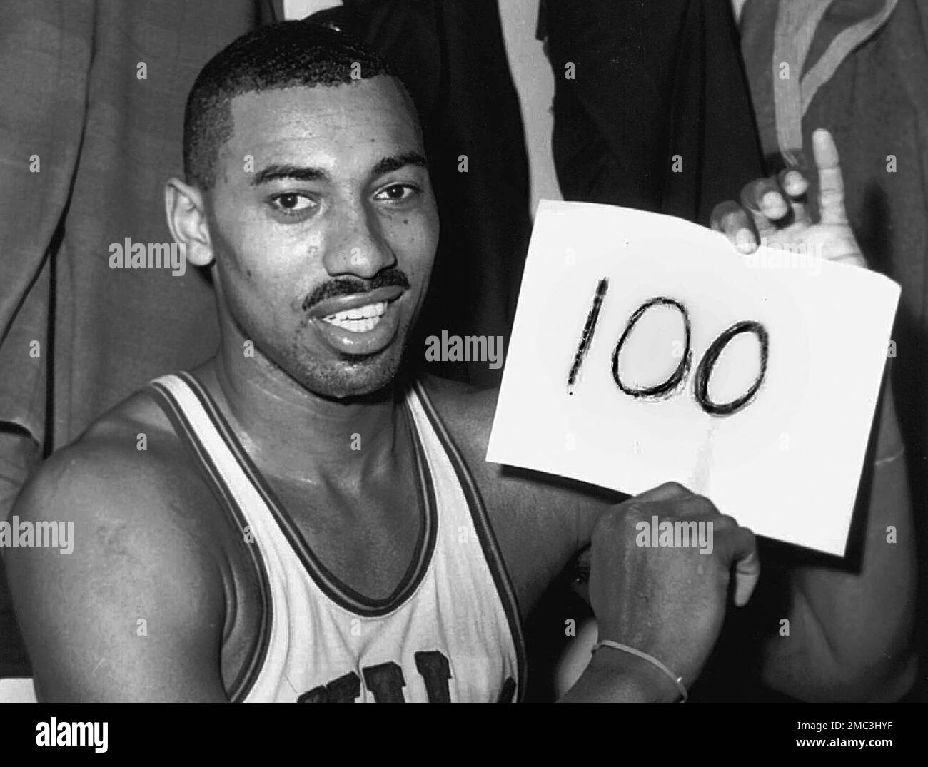 FILE - Wilt Chamberlain, of the Philadelphia Warriors, holds a sign ...