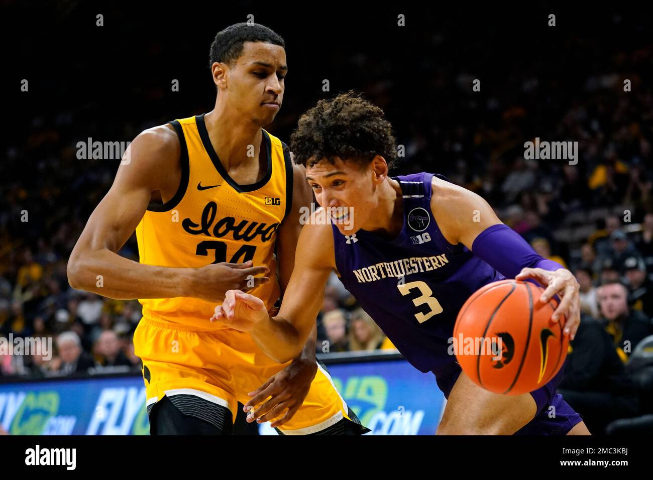 Northwestern guard Ty Berry (3) drives to the basket past Iowa forward ...