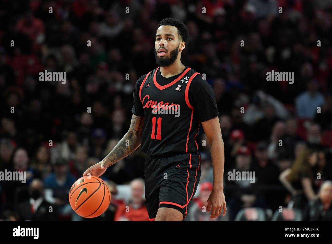 Houston guard Kyler Edwards (11) brings the ball up court against SMU ...