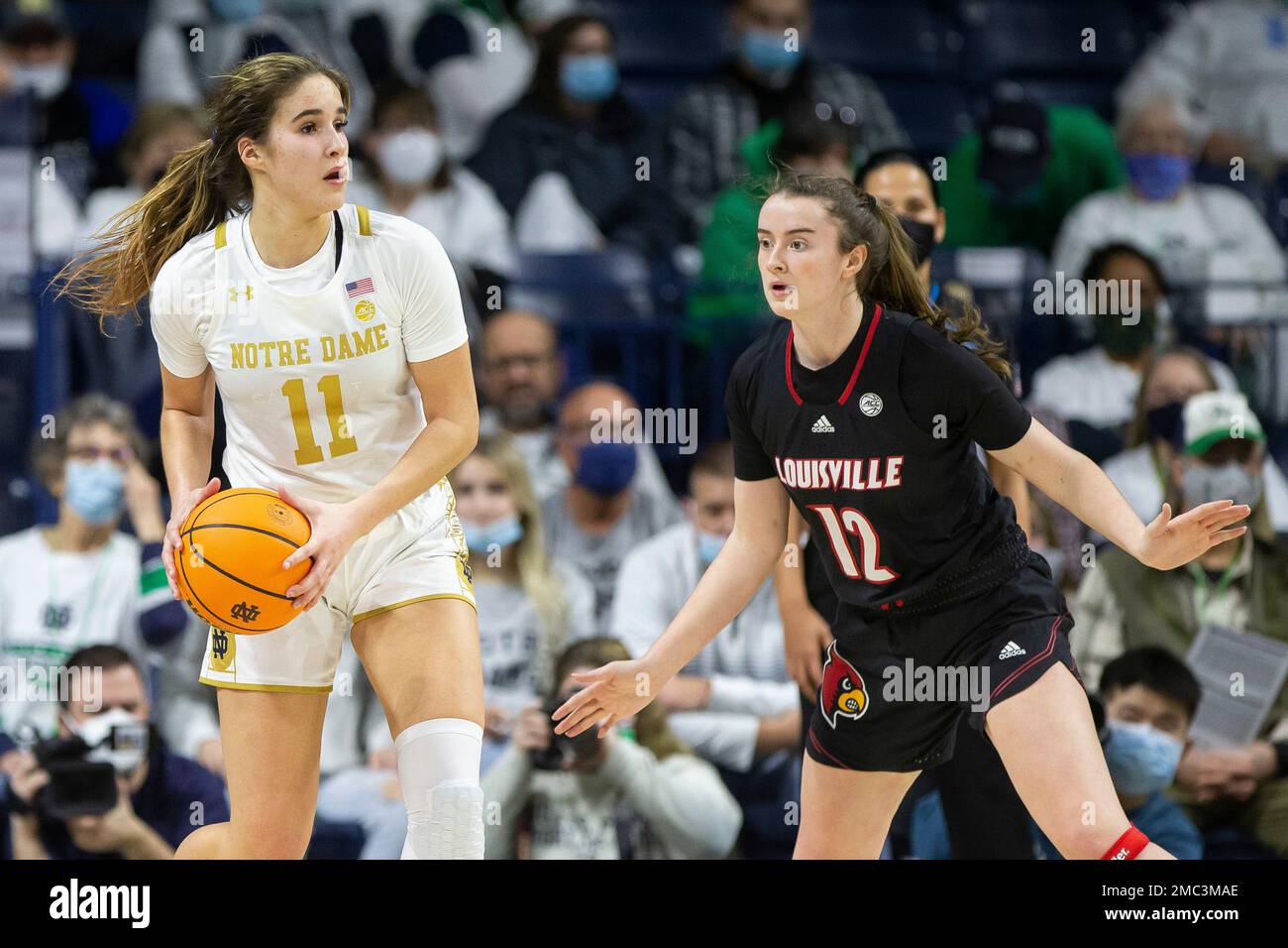 Notre Dame's Sonia Citron (11) looks to pass around Louisville's Payton ...