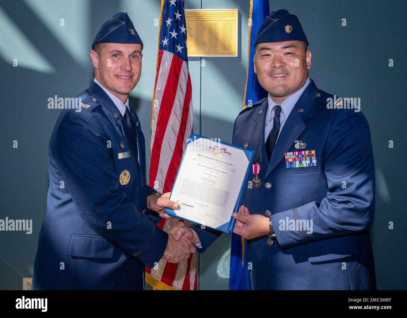 Col. Lucas Teel, left, 4th Fighter Wing commander, presents Maj. Samuel ...