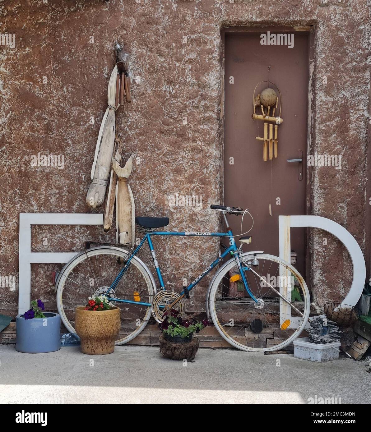 A decorated restaurant entrance with a bicycle and plant pots Stock ...