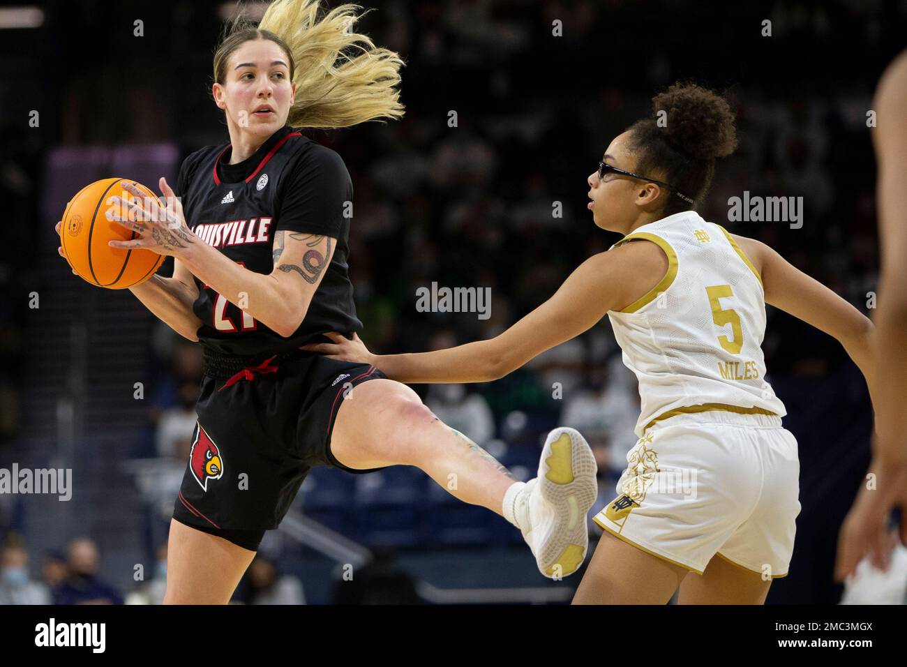 Louisville's Emily Engstler (21) grabs a high pass over Notre Dame's ...